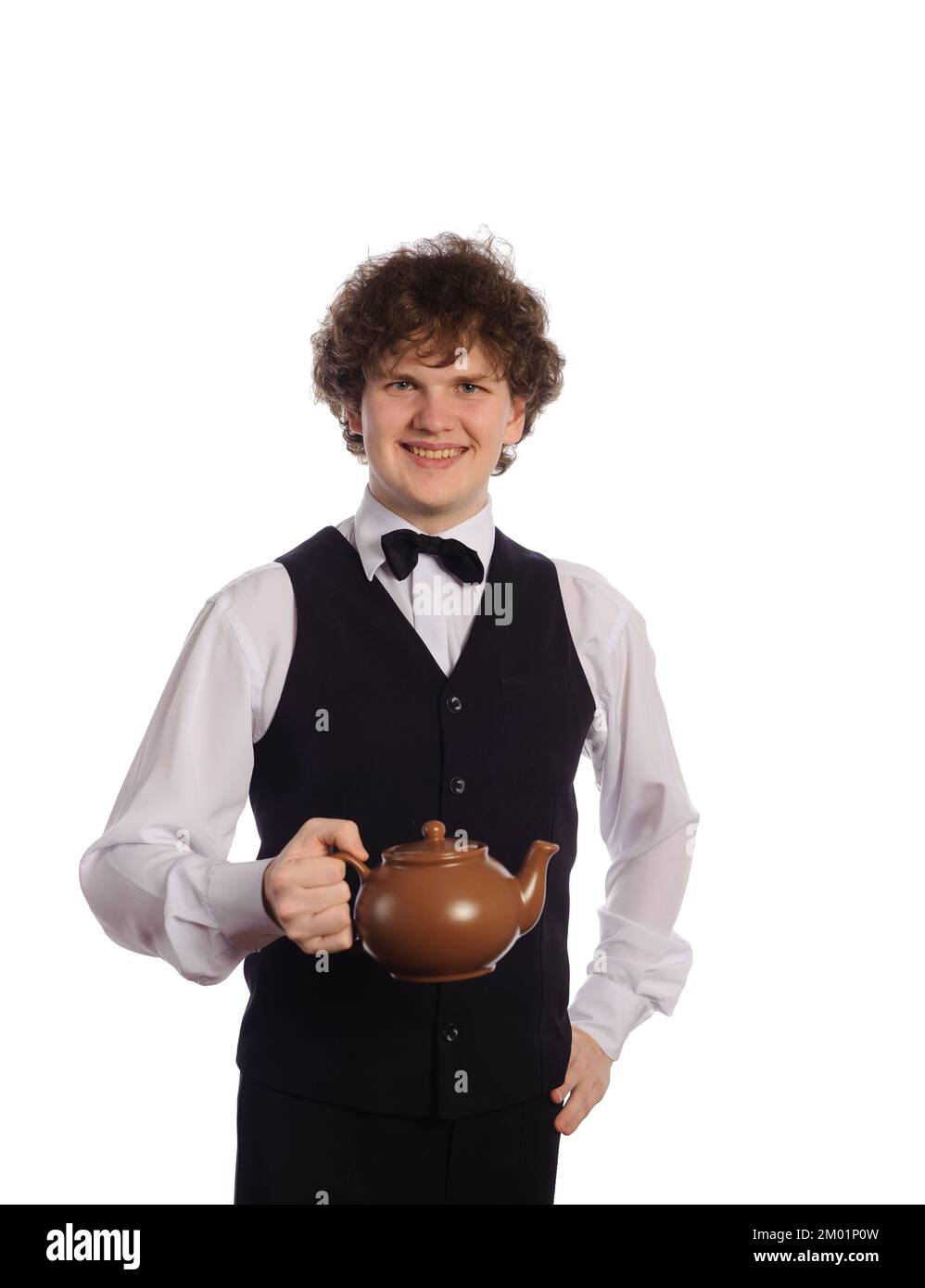 young handsome smiling waiter with brown ceramic teapot, isolated on ...