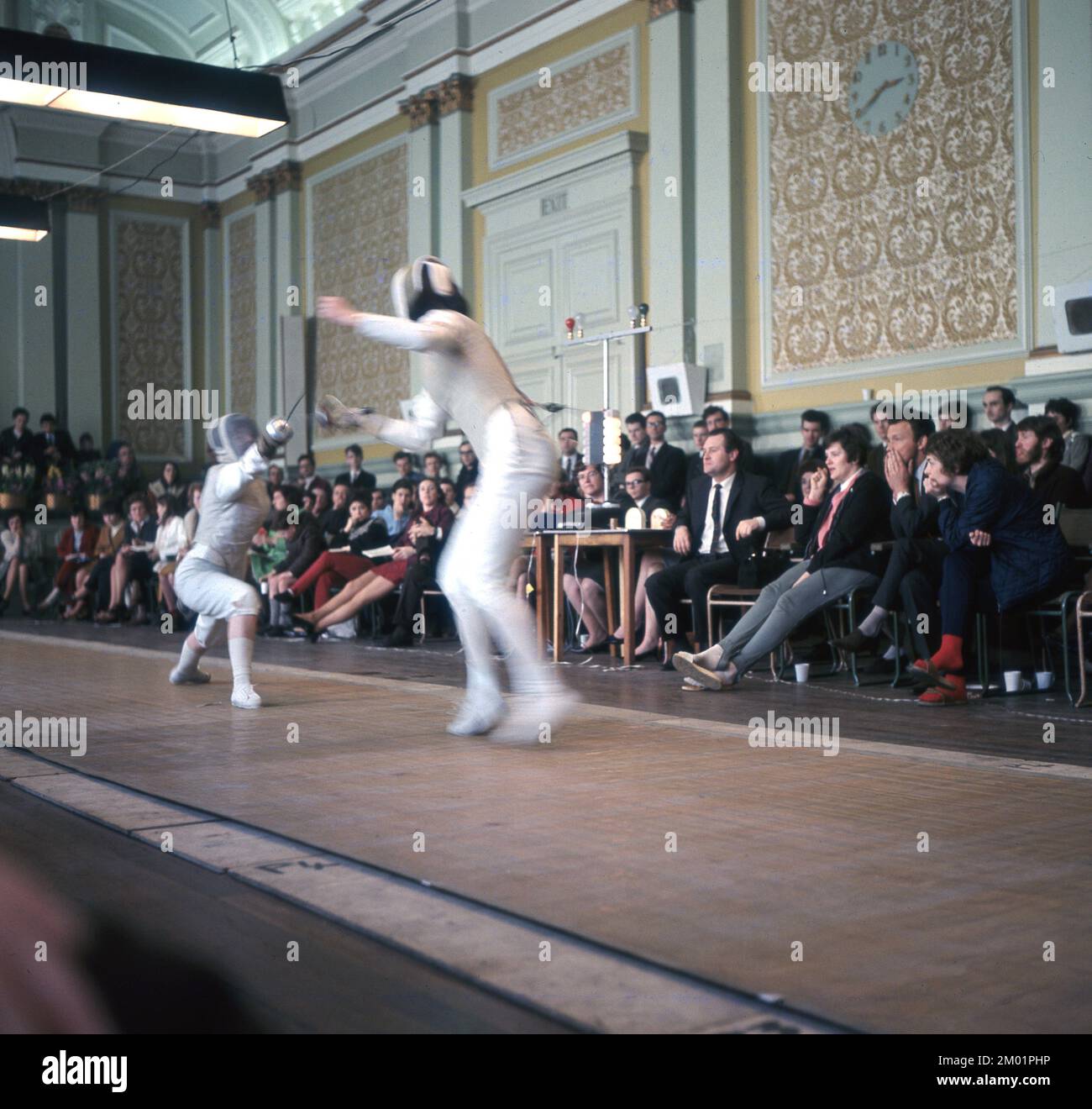 1970s, historical, fencing competition, two fencers fighting against ...