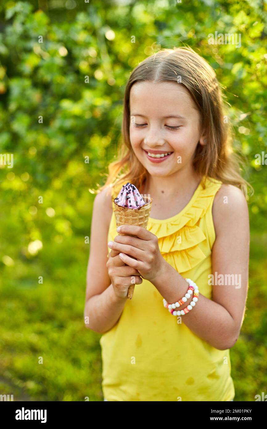Happy girl with braces eating italian ice cream cone smiling while ...