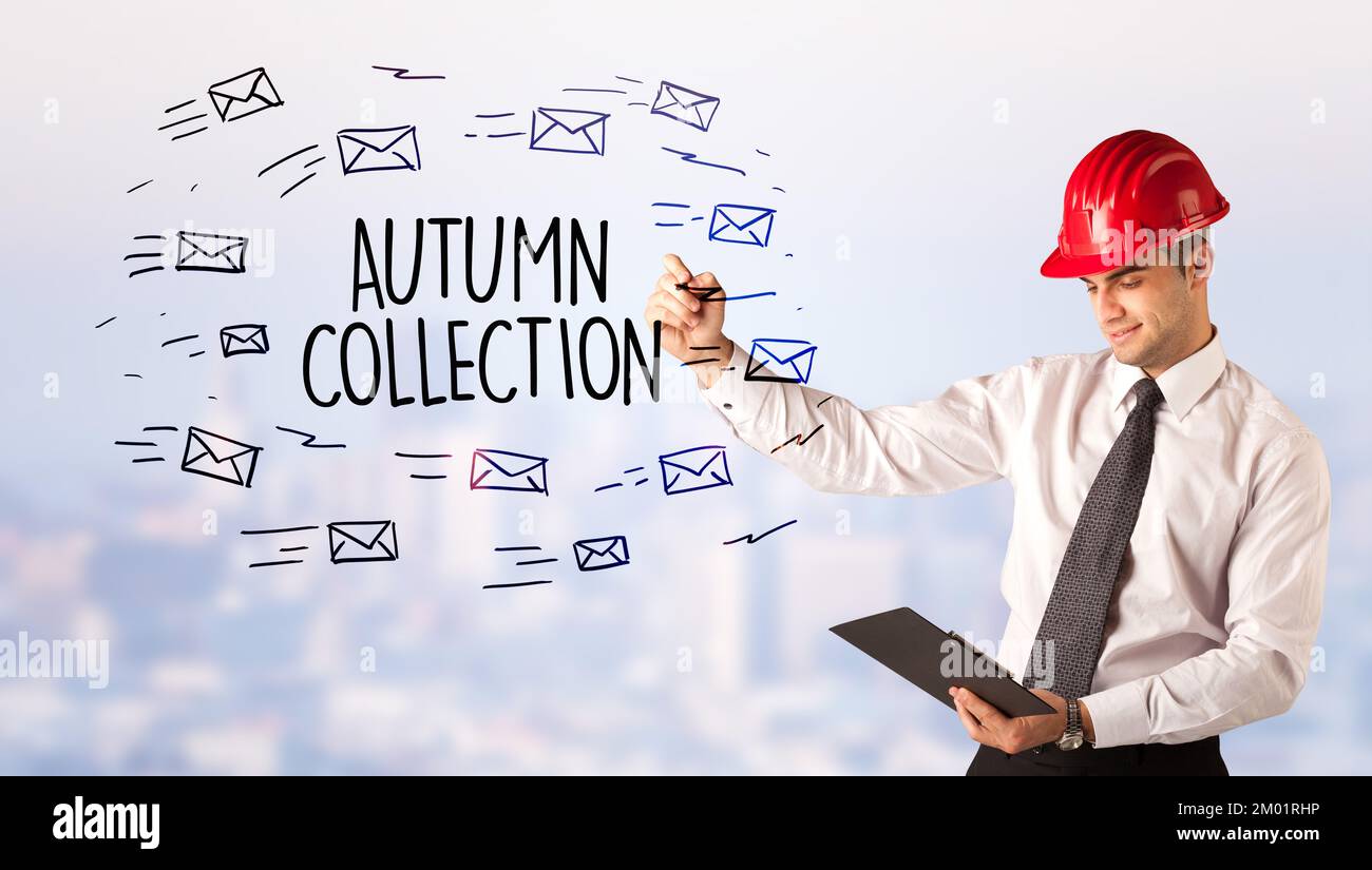 Young businessman with helmet drawing sale sign Stock Photo - Alamy