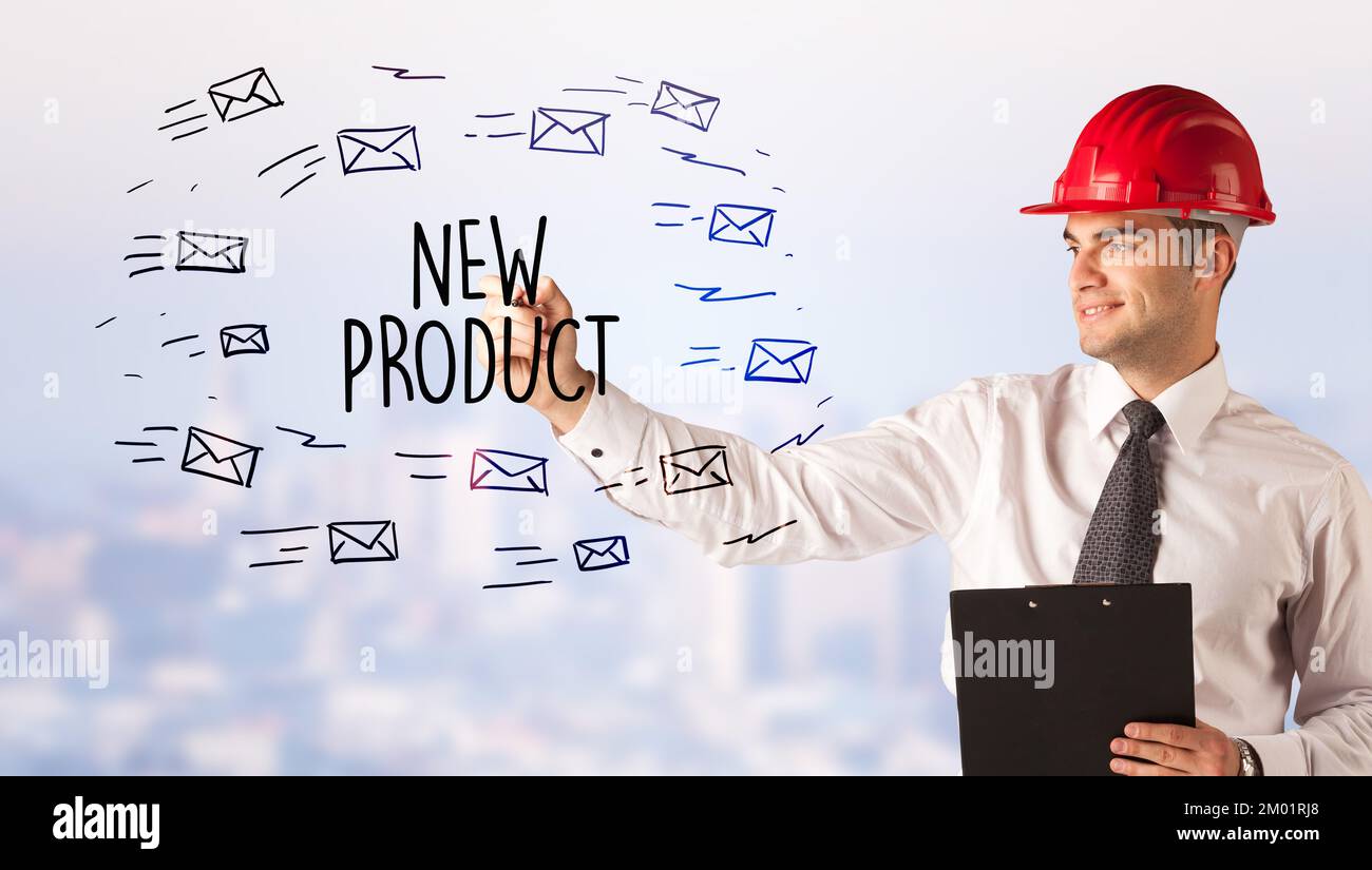 Young businessman with helmet drawing sale sign Stock Photo - Alamy