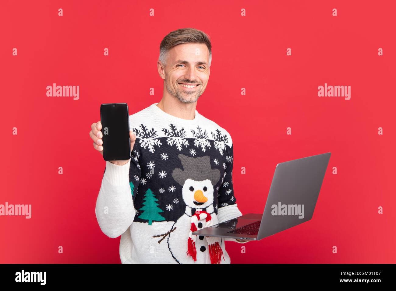 Winter man with laptop compute and phone screen. Middle aged santa. Man ...