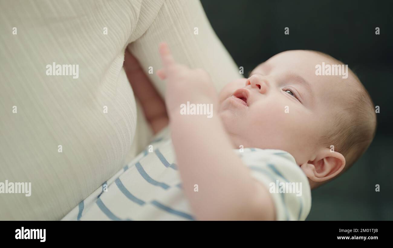Adorable caucasian baby on mother arms at home Stock Photo - Alamy