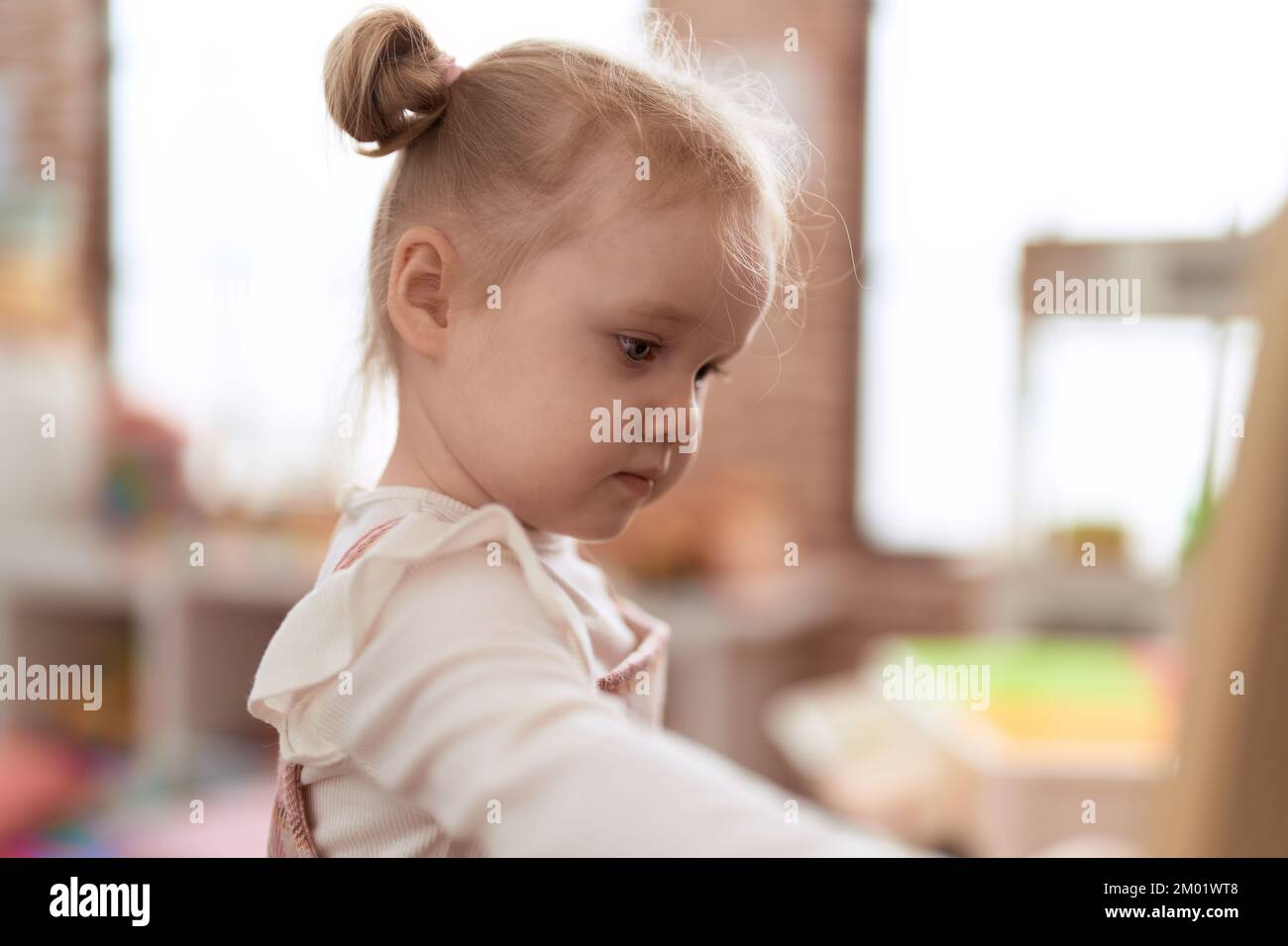 Adorable caucasian girl standing with relaxed expression at ...