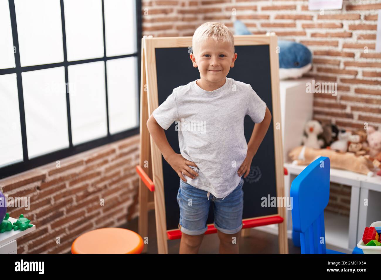 Adorable toddler smiling confident standing at classroom Stock Photo ...