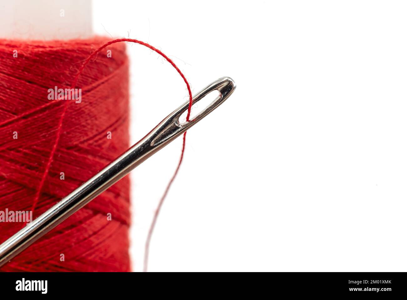 Needle with multi-colored threads on a white background. Eye of a ...