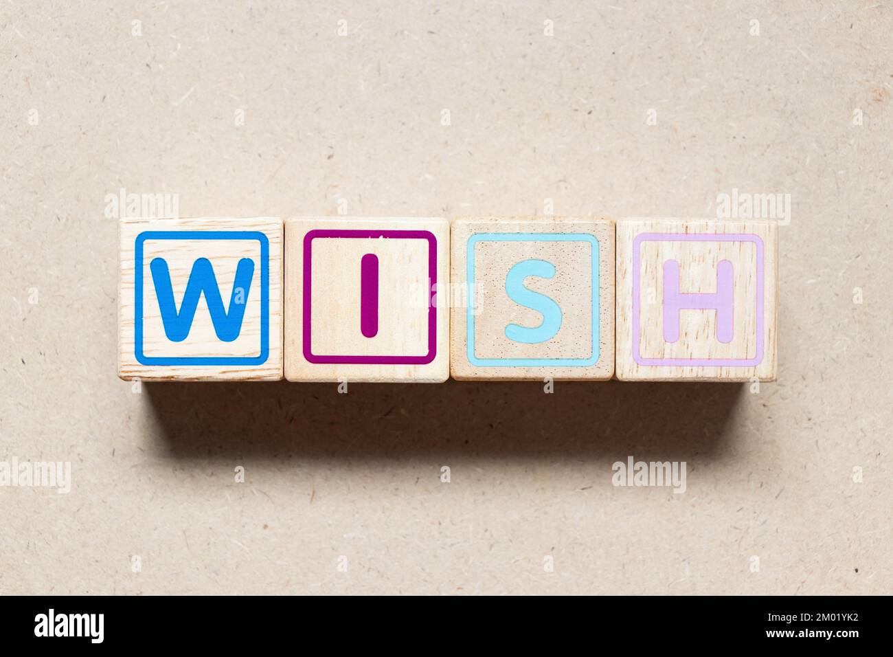 Color letter block in word wish on wood background Stock Photo - Alamy