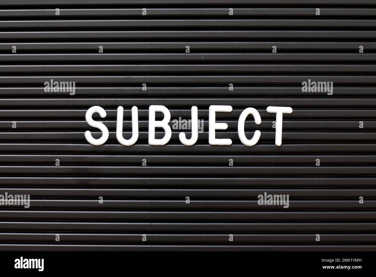 White alphabet in word subject on black color felt letter board ...