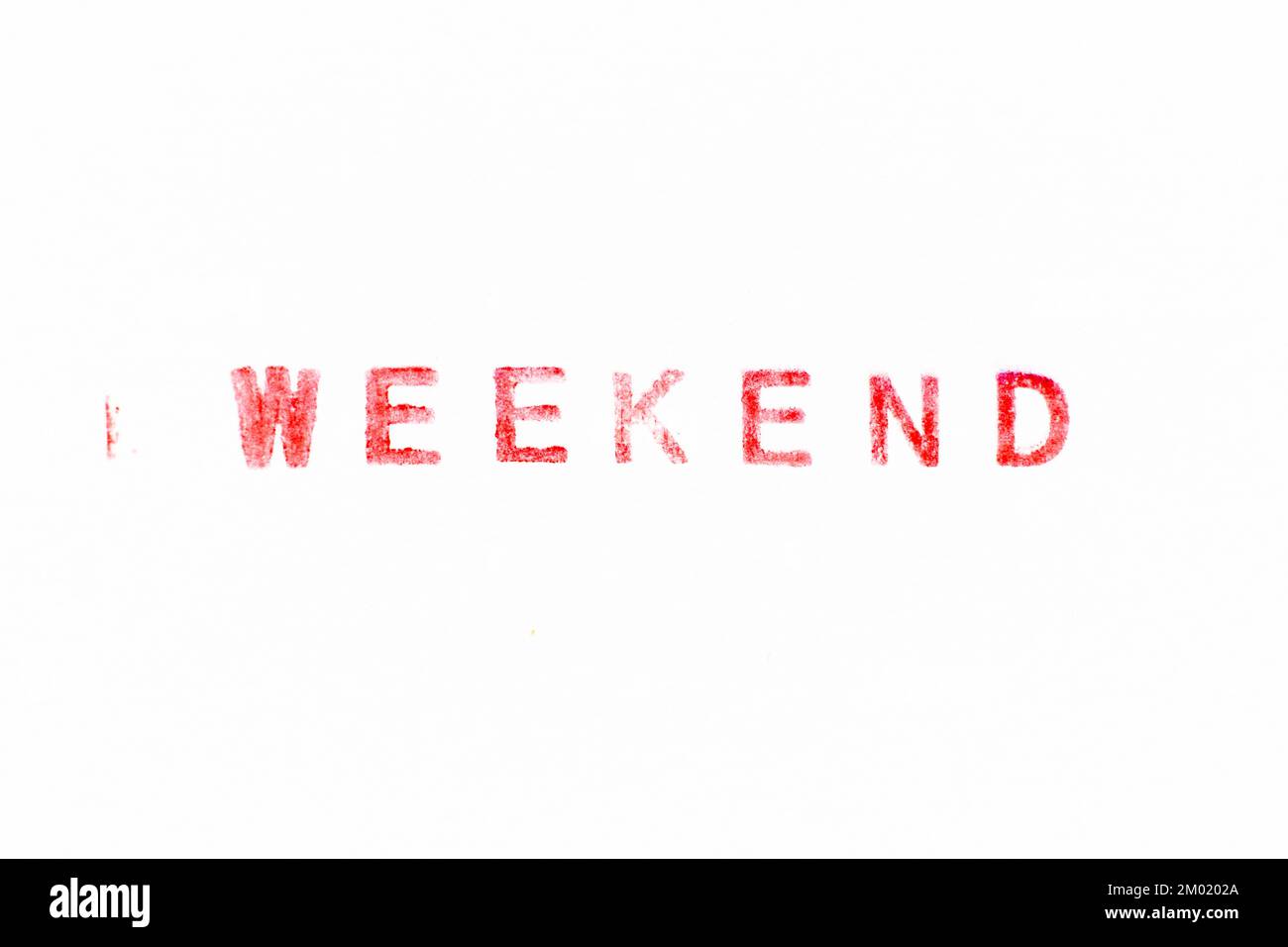 Red color ink rubber stamp in word weekend on white paper background ...