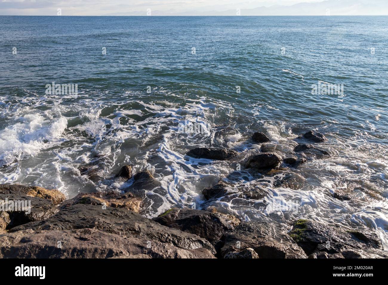 Shore water and wet coastal rocks. Summer landscape with splashing sea ...