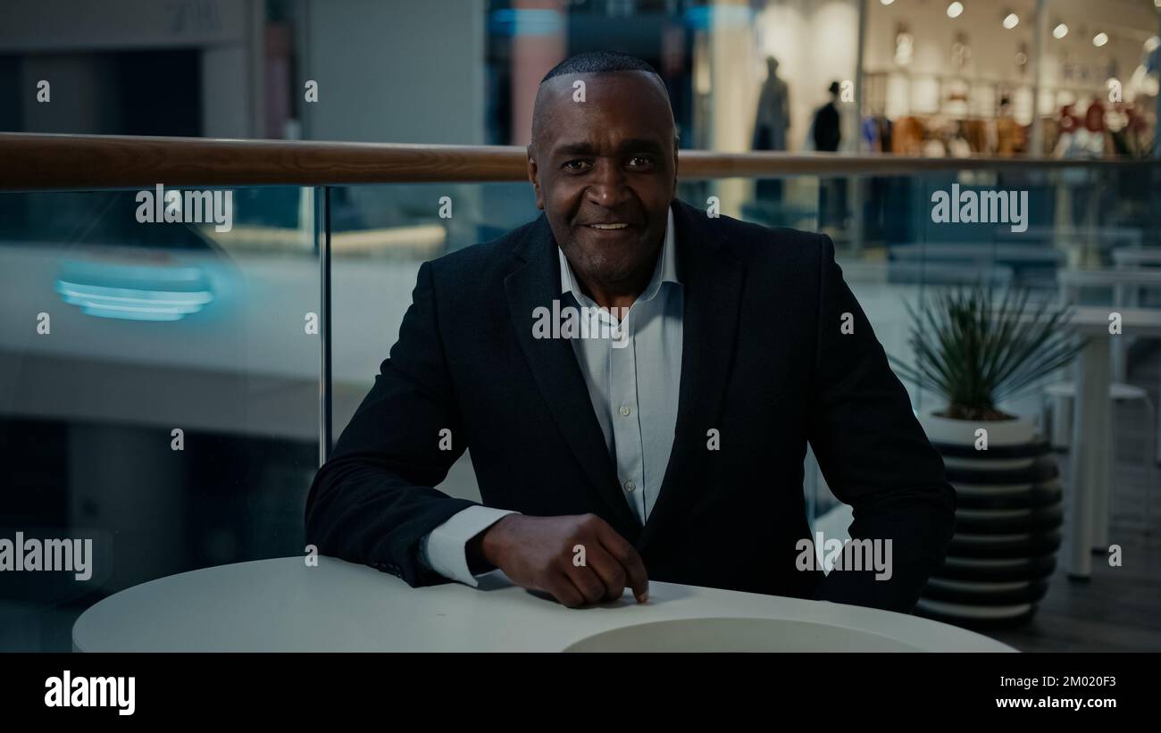 African adult middle-aged businessman visitor client man come in cafe ...