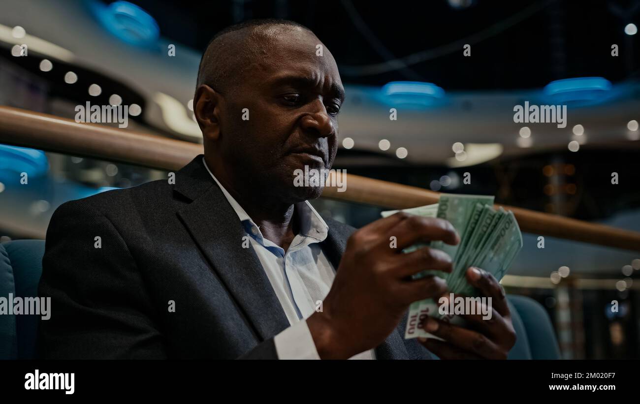 Middle aged businessman counting dollars hi-res stock photography and ...