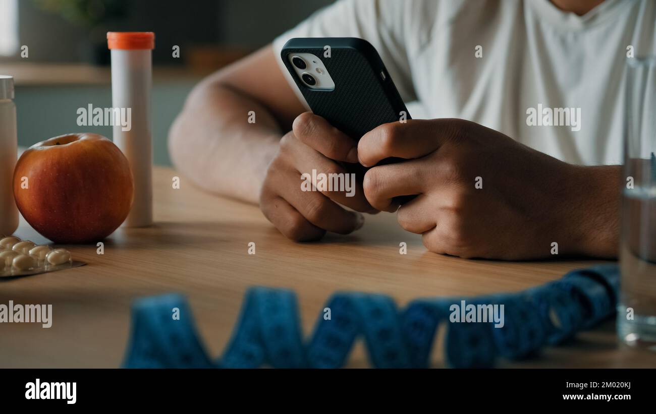 Close up male hands browsing mobile phone guy nutritionist ...