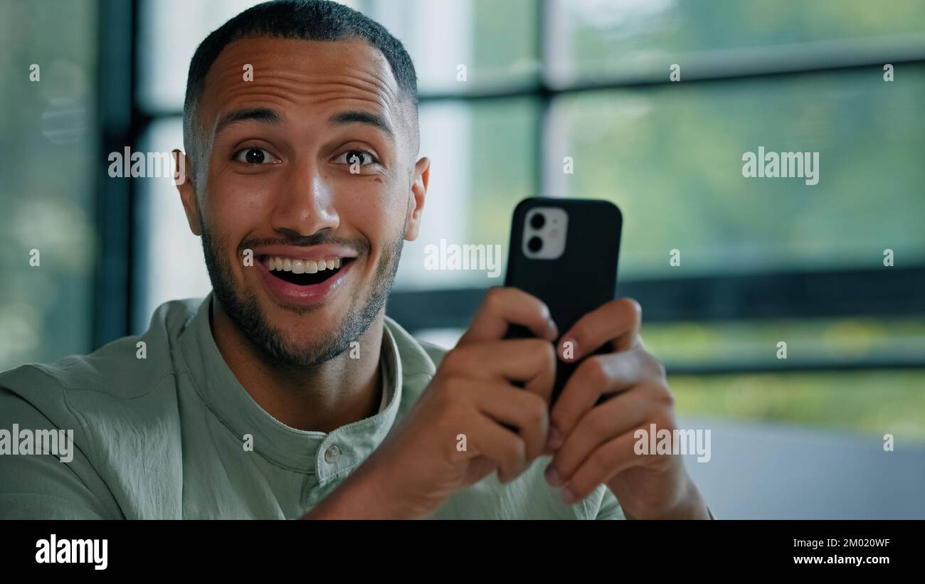 Emotional male man African businessman guy entrepreneur looking mobile ...