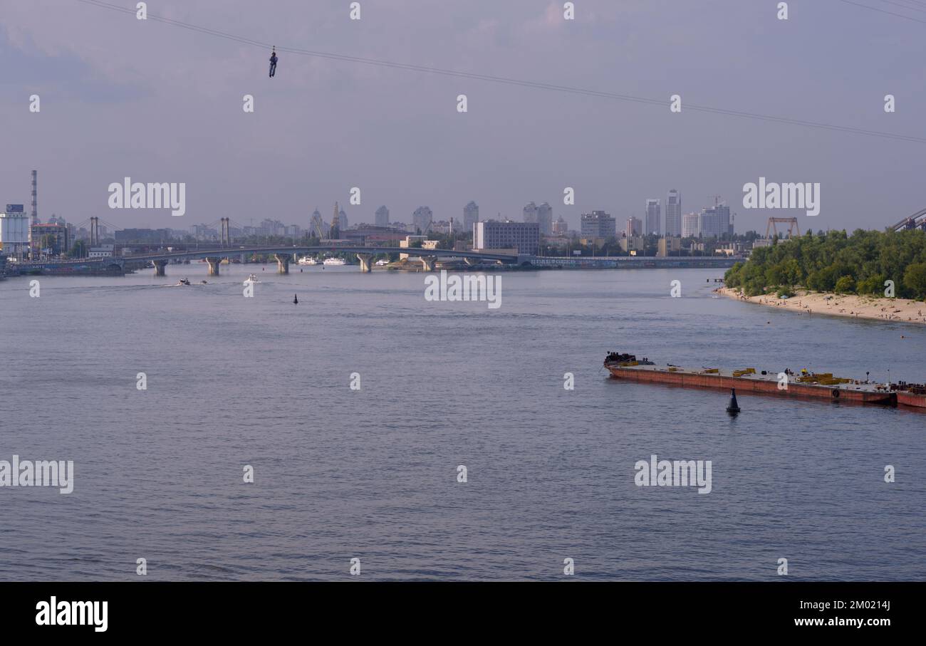Large barge floating on the Dnipro river, Truhanov island sandy beach ...