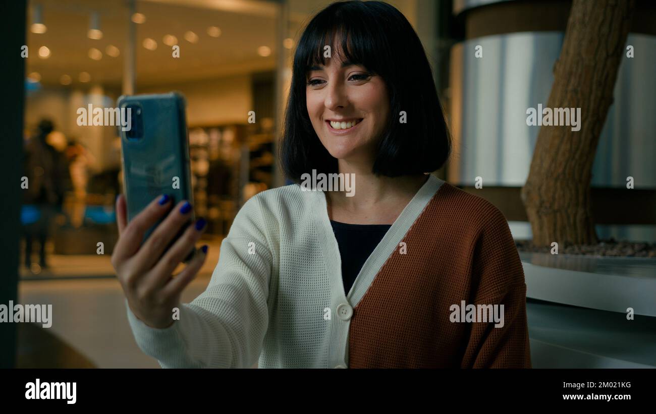 Smiling positive talking to smartphone webcam woman has video call ...