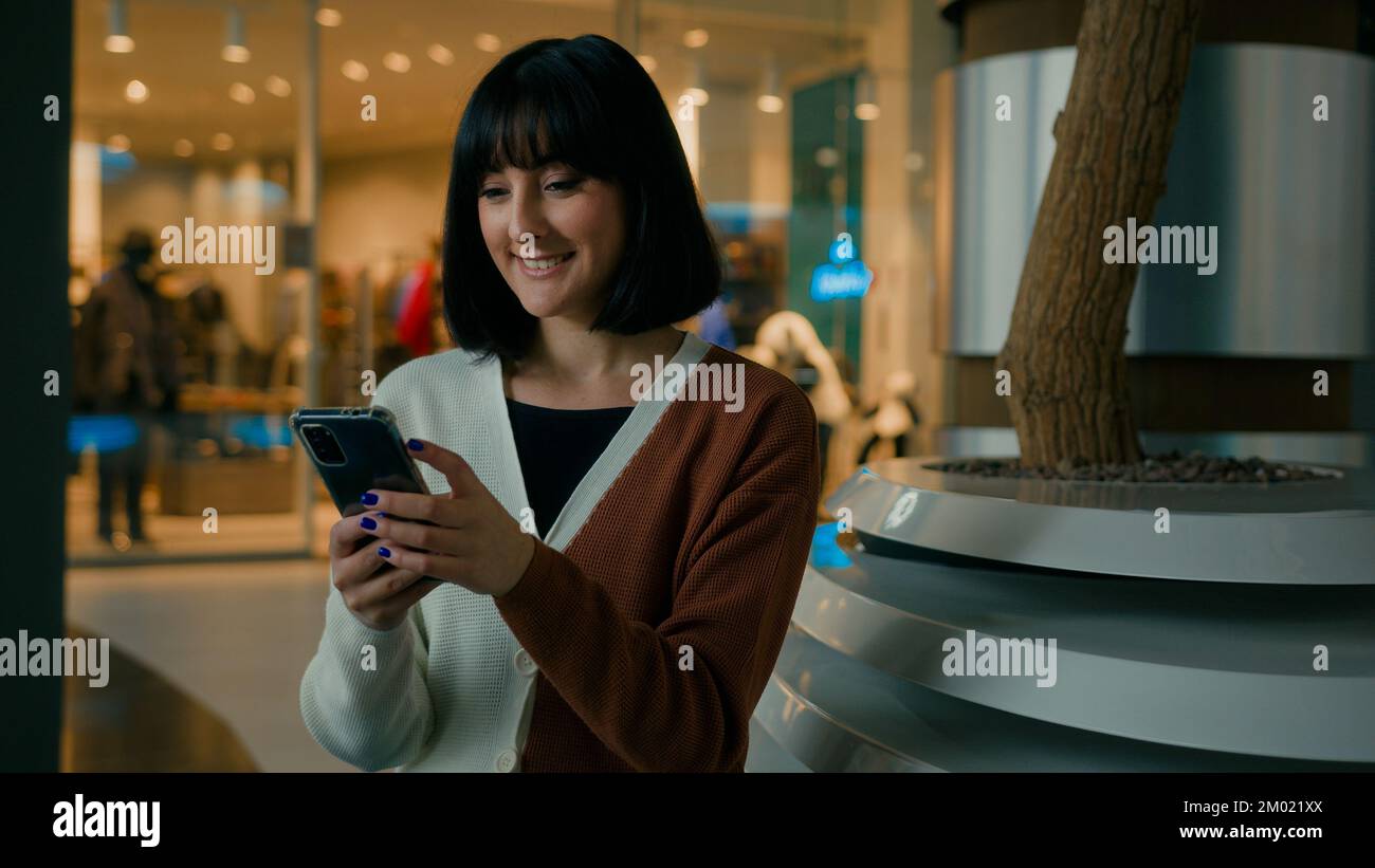 Smiling 20s Woman Lady Female Girl Indoors In Shopping Mall Sitting