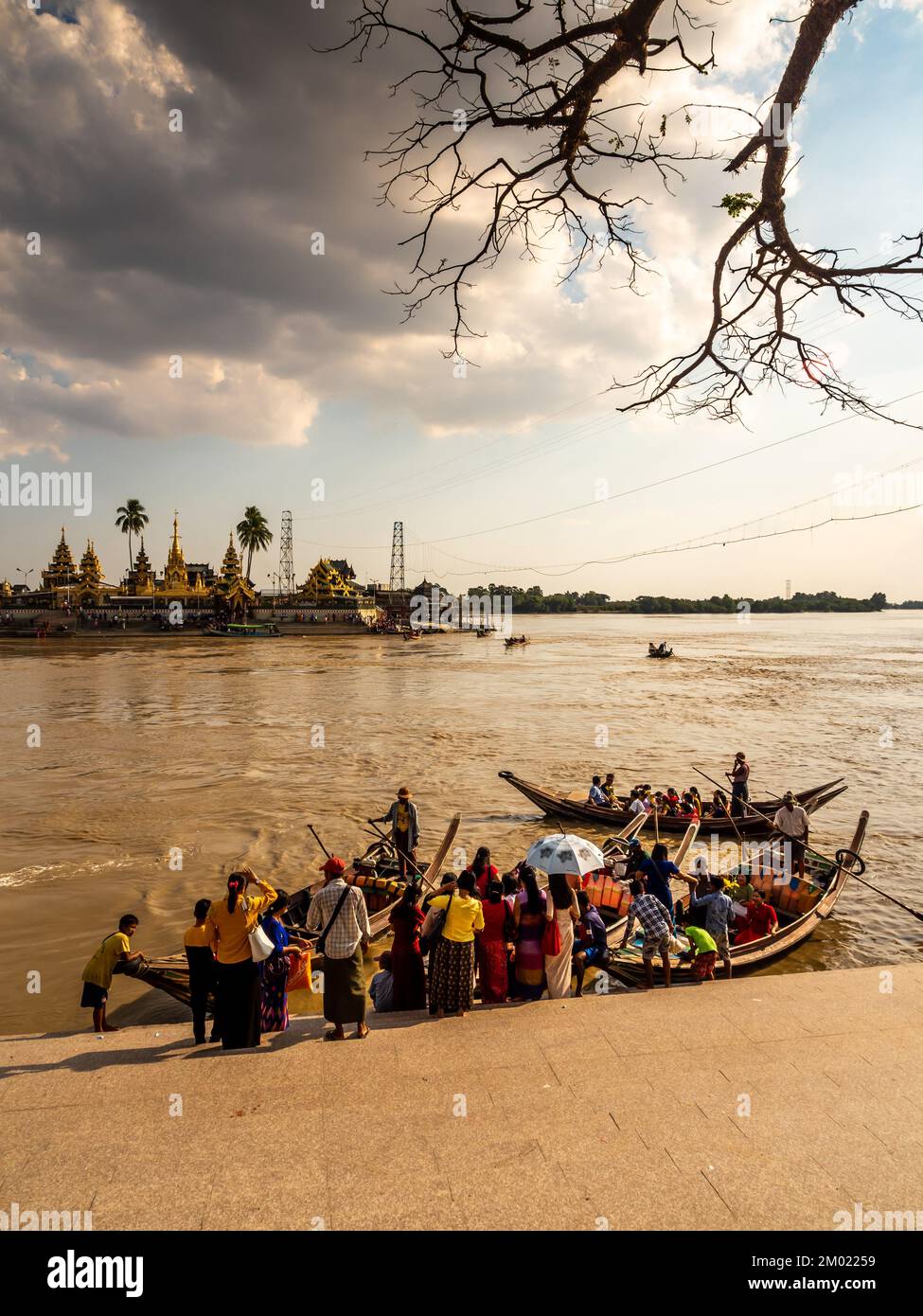 Yangon, Myanmar - Jan 4, 2020 People and tourists boarding a small boat ...