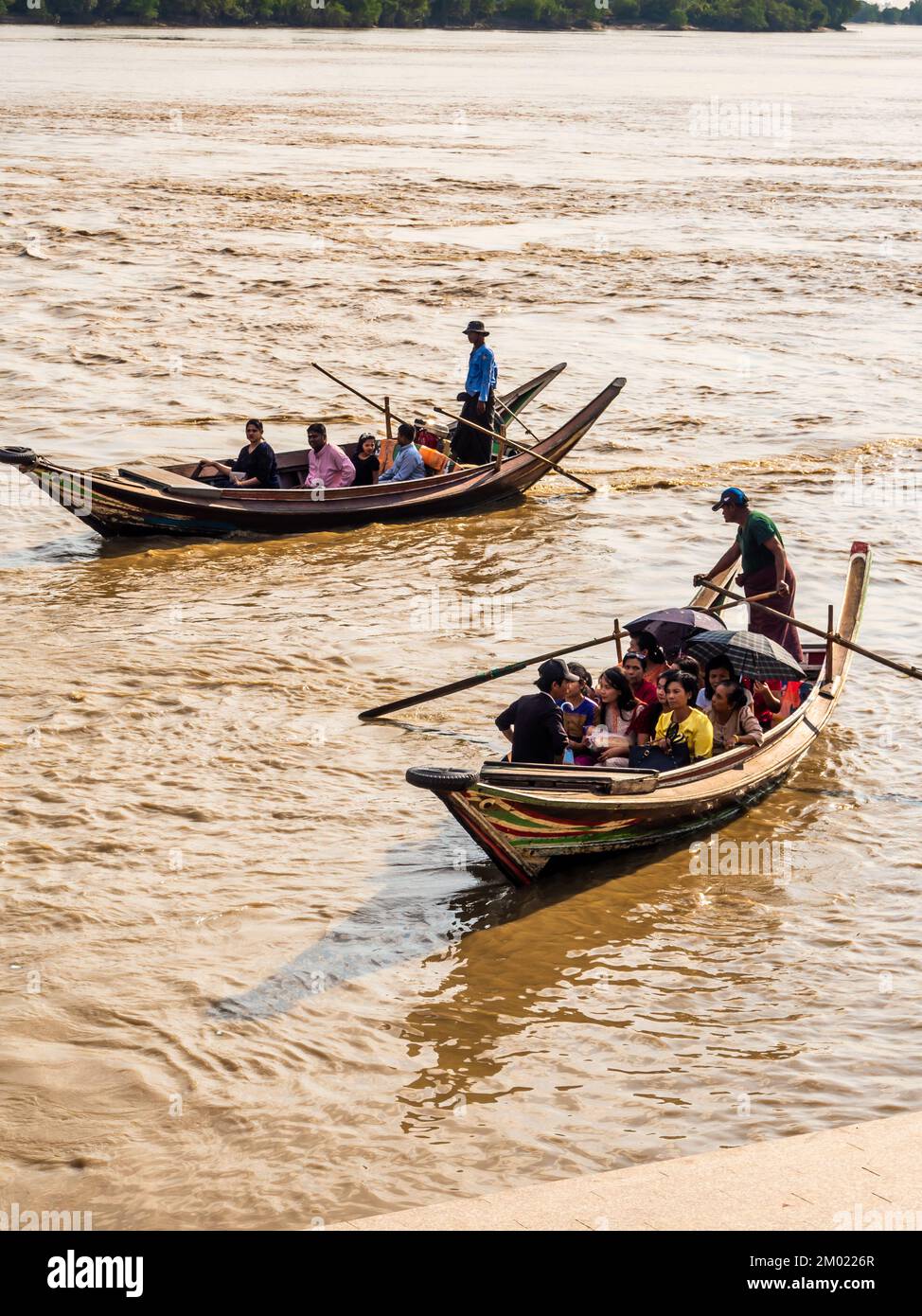 Yangon, Myanmar - Jan 4, 2020 People and tourists boarding a small boat ...