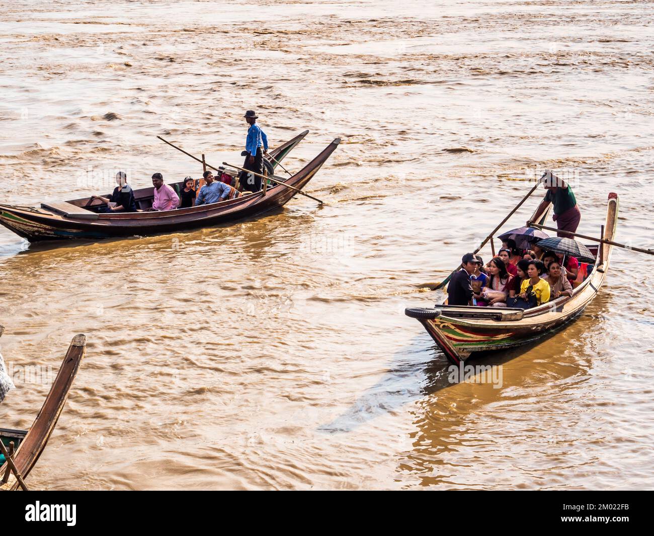 Yangon, Myanmar - Jan 4, 2020 People and tourists boarding a small boat ...