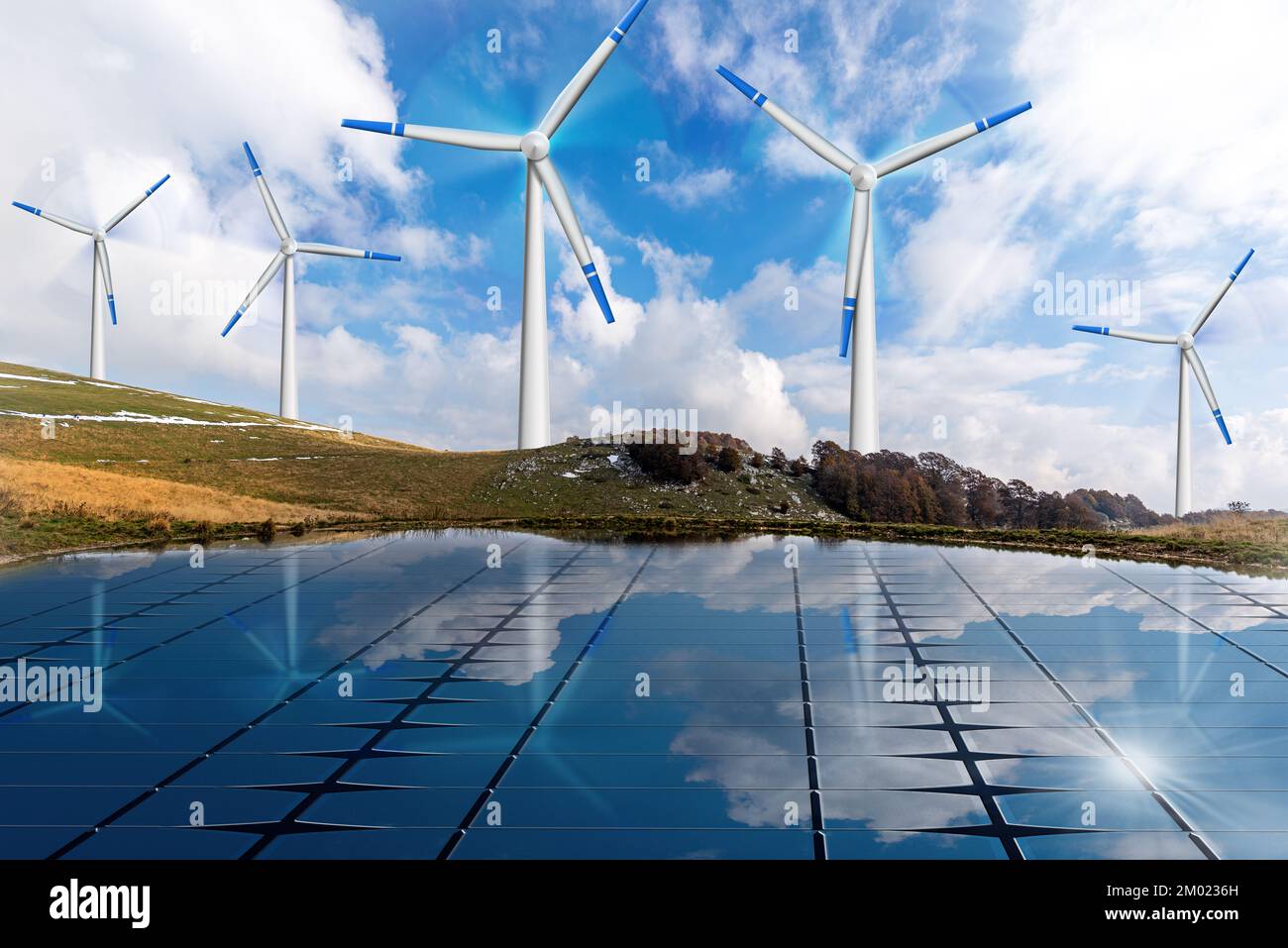 Group of wind turbines and solar panels on a mountain landscape against ...