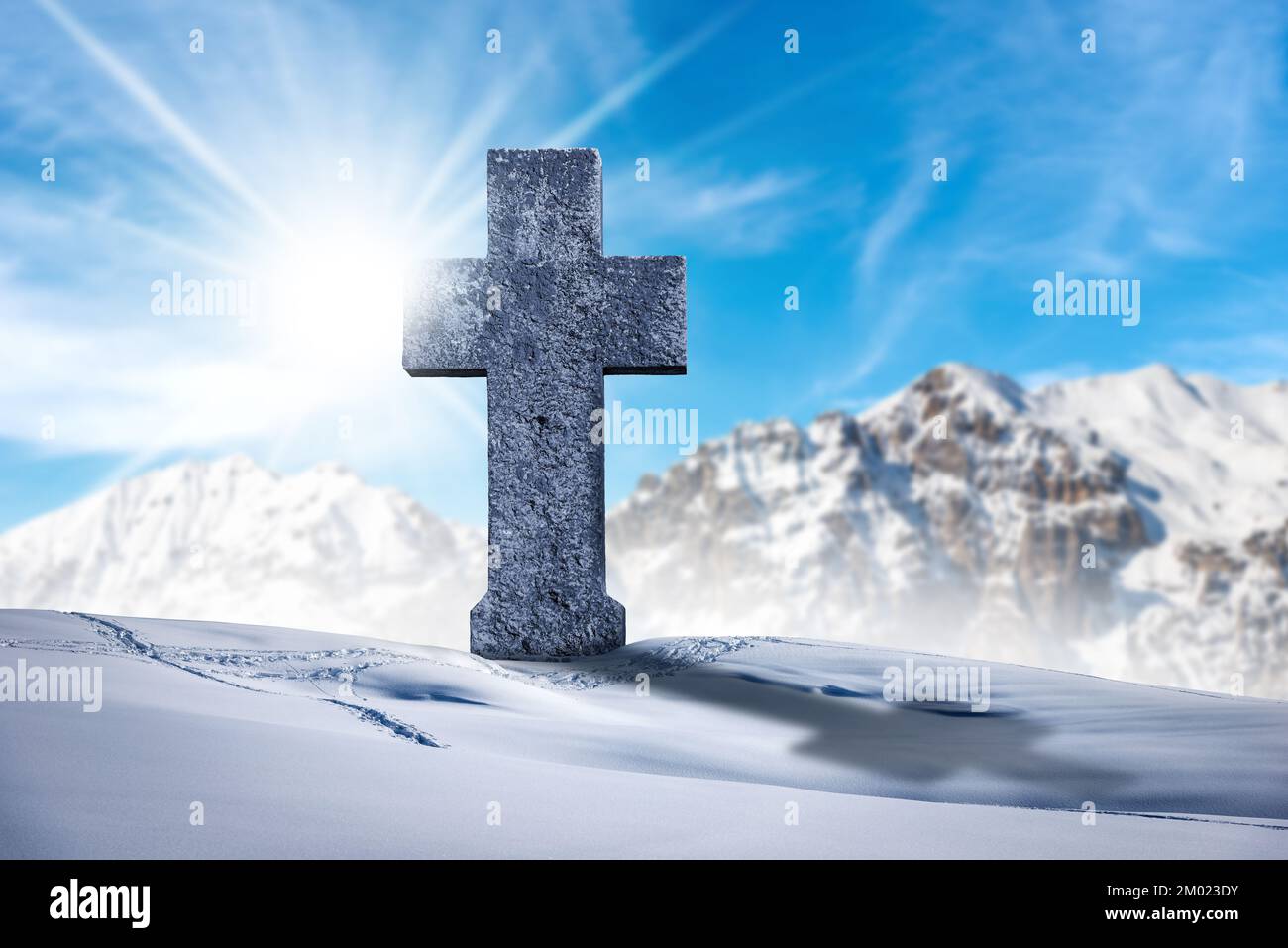 Large stone religious cross in a mountain landscape with snow against a ...
