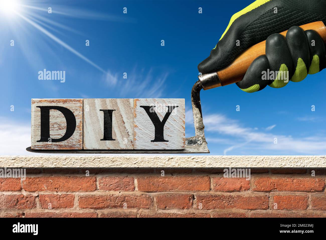 Manual worker with protective work gloves holding a dirty trowel and ...