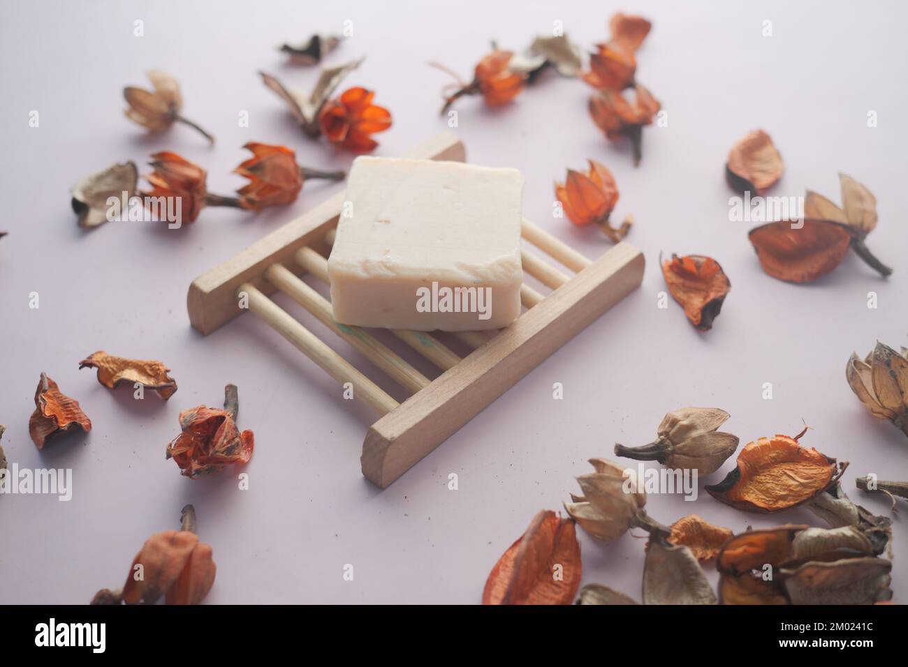 Homemade natural soap bar and dry flower on black background Stock ...