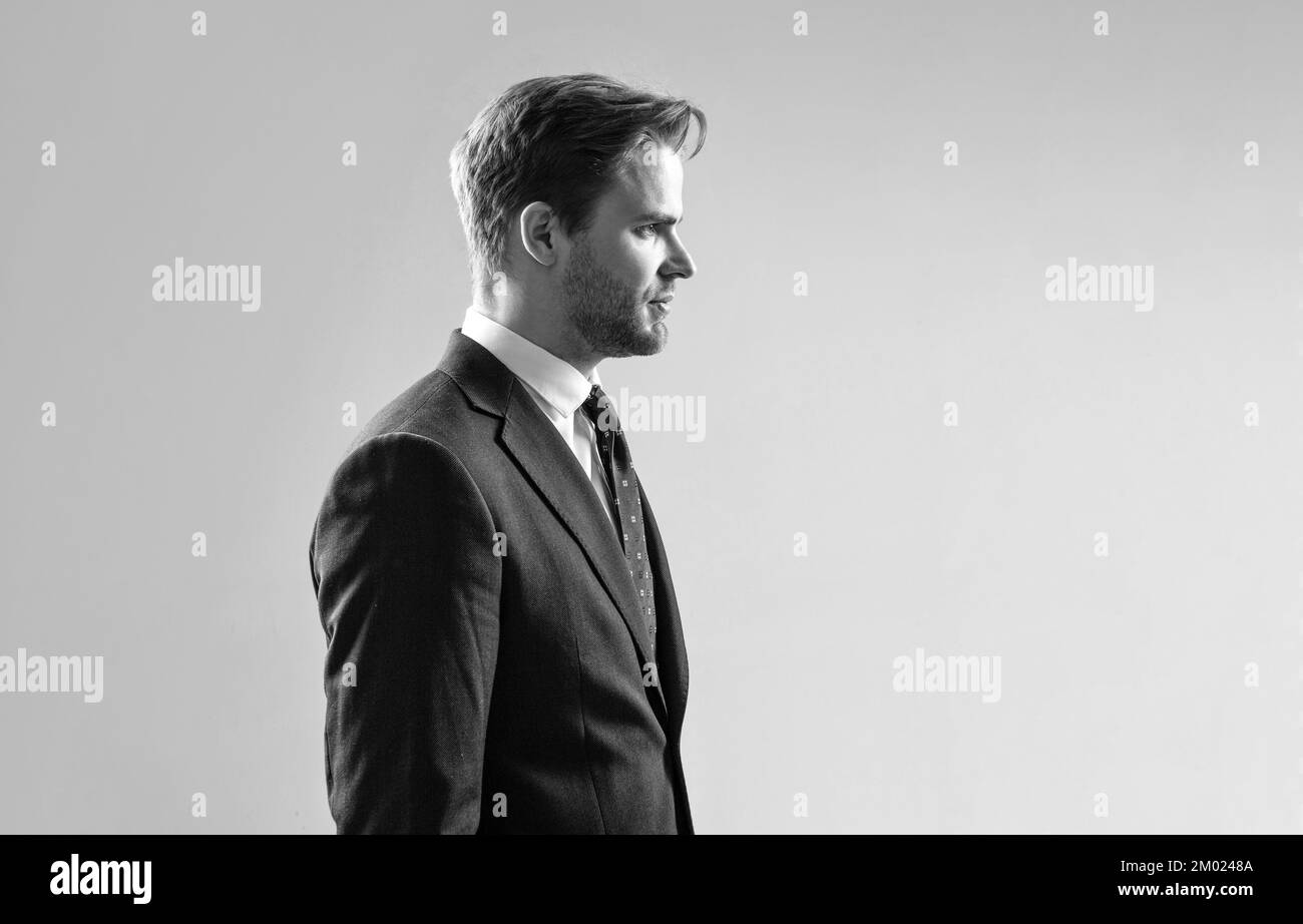 Treat him seriously. Serious guy stand sideway. Guy in formalwear grey ...