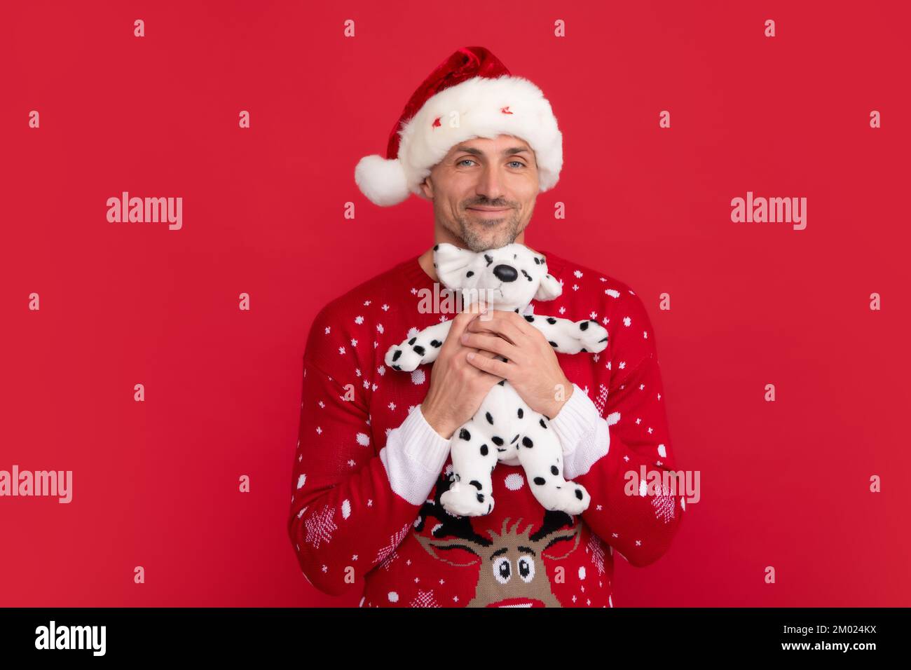 Portrait of middle aged man in sweater hold fluffy toy, gift for baby ...