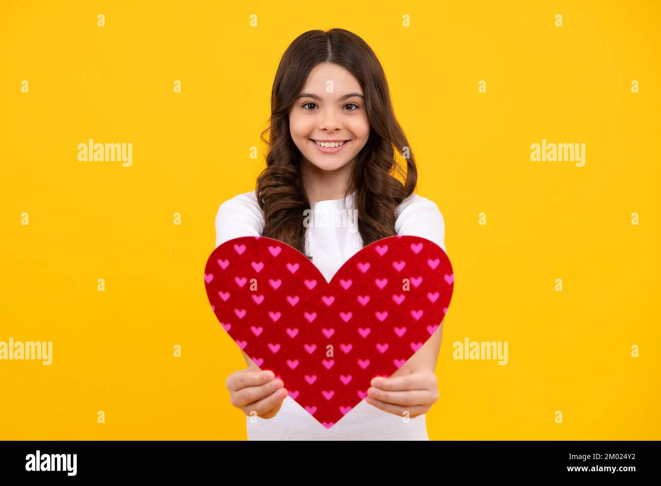 Lovely romantic teenage girl hold red heart symbol of love for ...