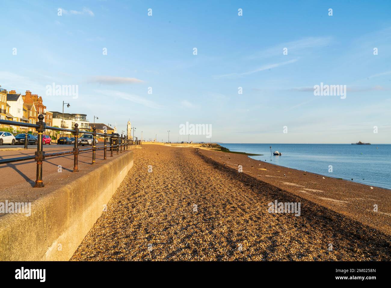 The central Parade and stone beach at Herne Bay seafront on a early ...