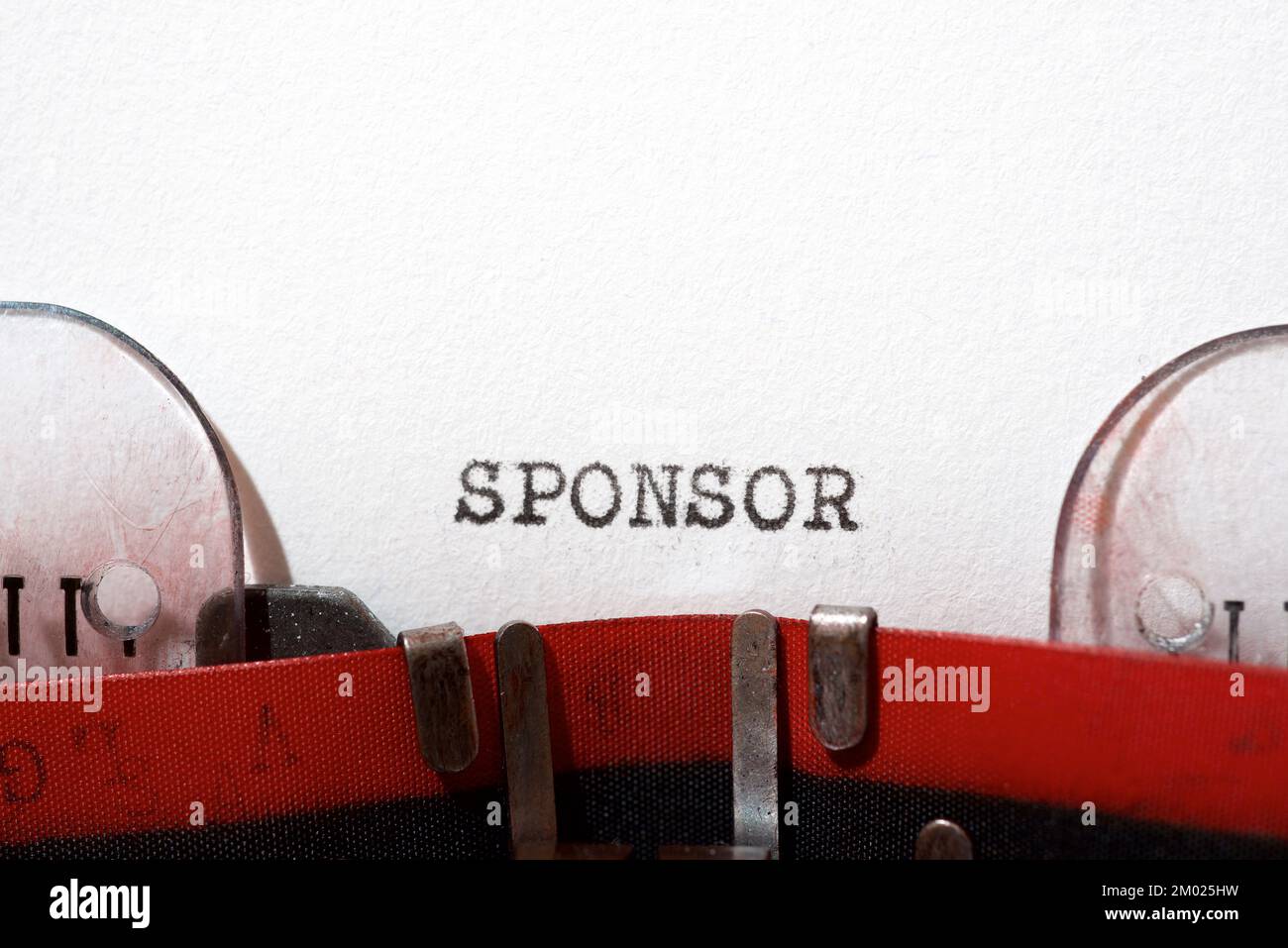 Sponsor text written with a typewriter Stock Photo - Alamy