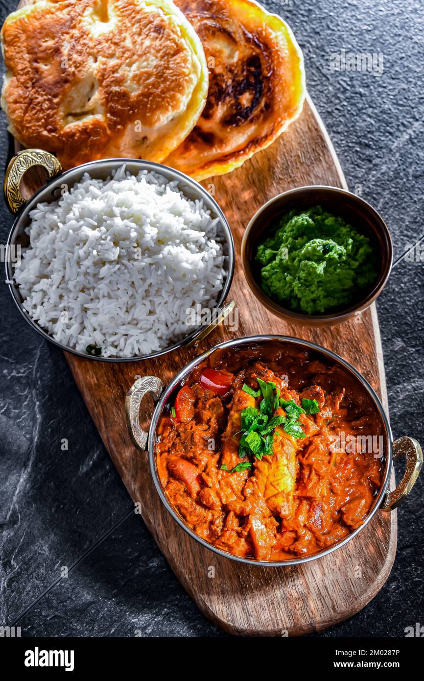 Butter chicken with rice and naan flatbread served in original indian ...