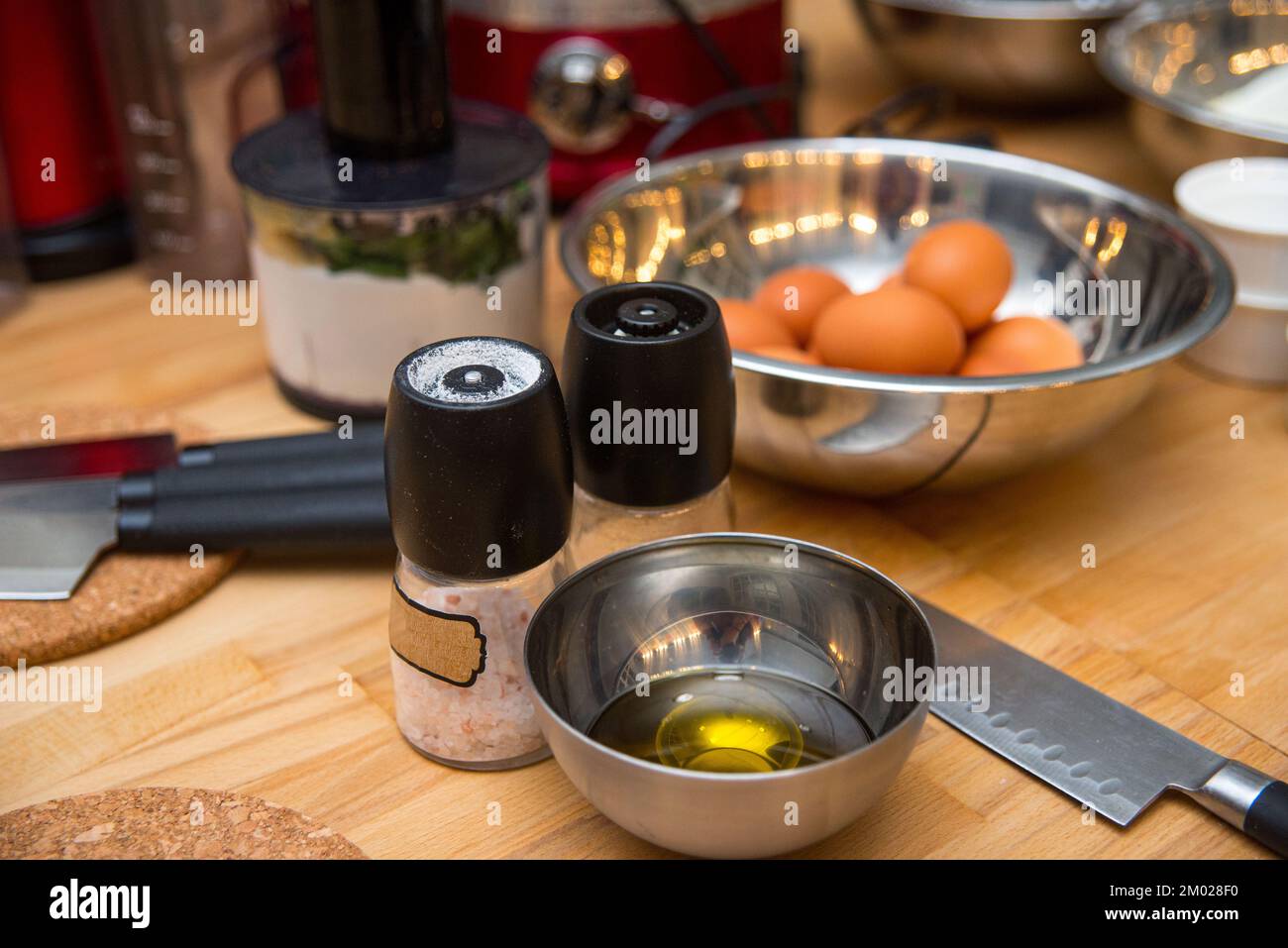 kitchen table with ingredients and utensils before cooking. bowl with ...