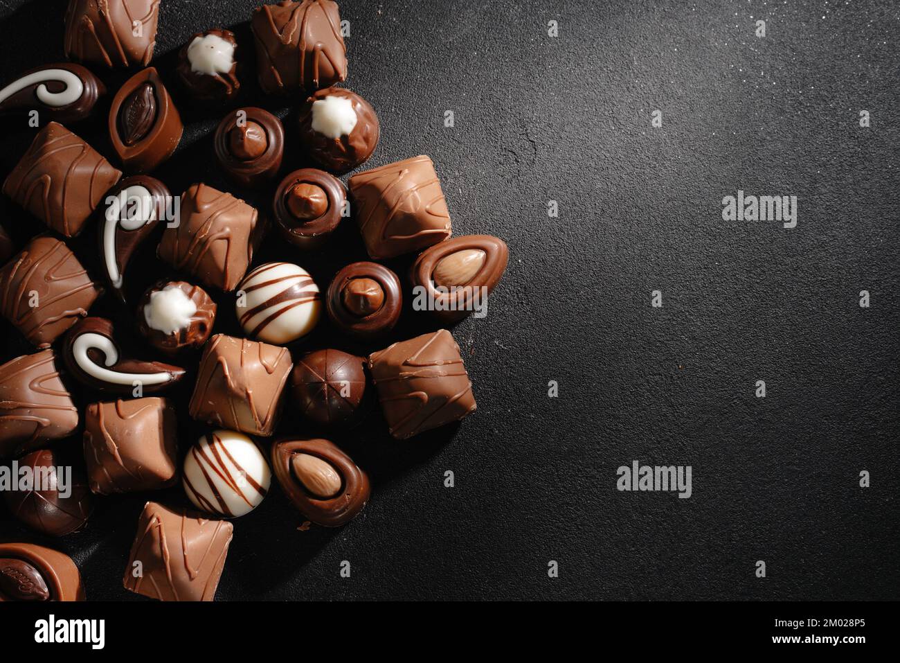 chocolate candies with various fillings, sweet food background. mix and ...