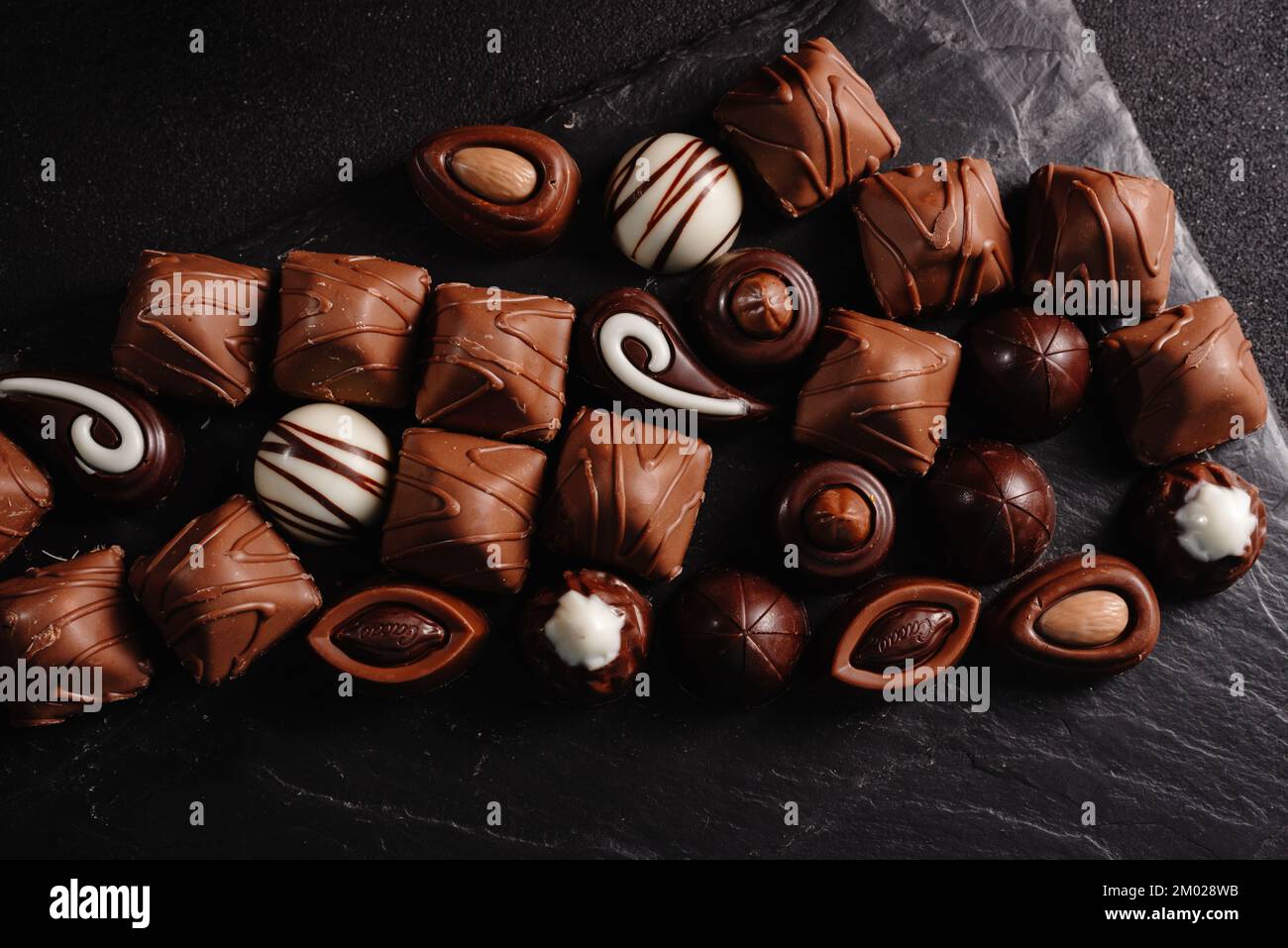 chocolate candies with various fillings, sweet food background. mix and ...