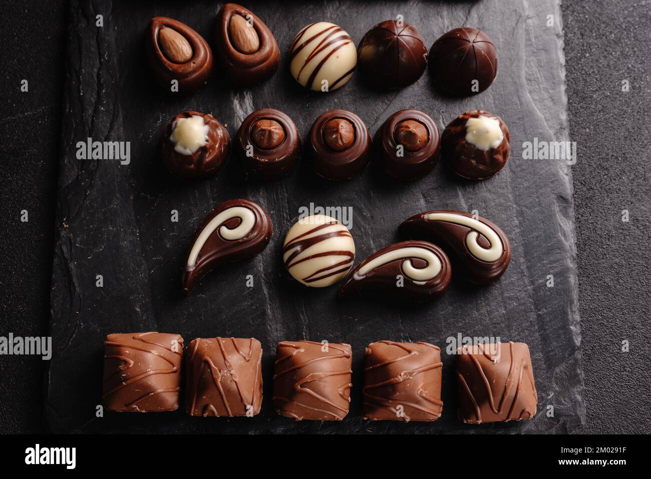 chocolate candies with various fillings, sweet food background. mix and ...