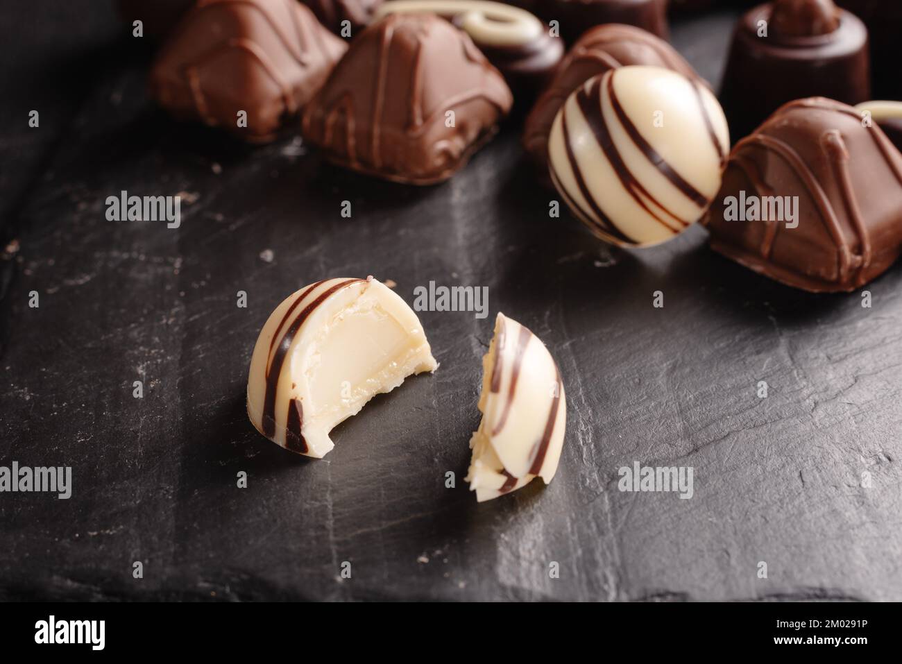 a bite of candy. Chocolate candies with different fillings Stock Photo ...