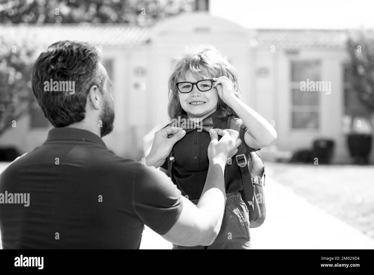 first day at school. father and son come back from school. happy family ...