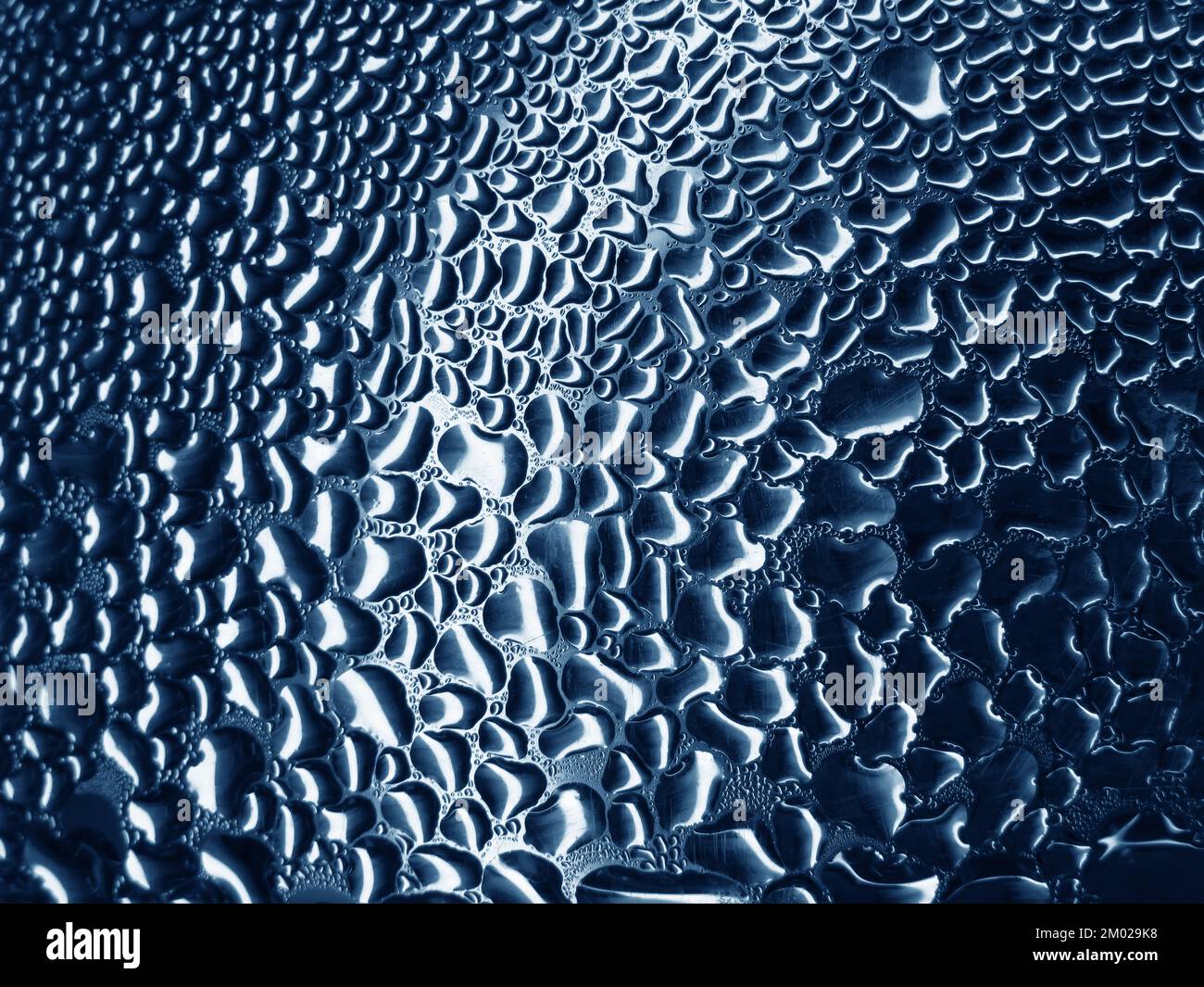 Glass with raindrops on blue tone background. Abstract ultramarine wet ...