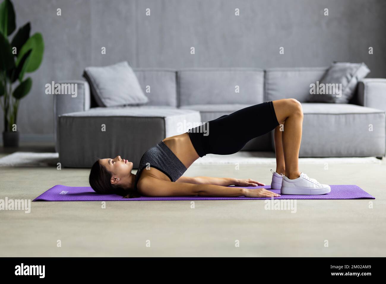 Yoga training at home - woman doing wild thing backbend pose in living ...