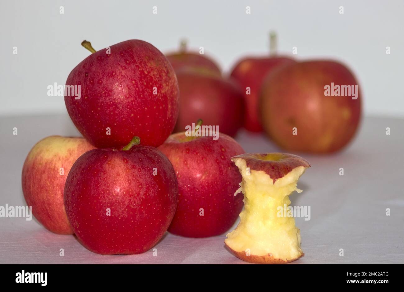 grouping of red apples, one of them bitten, on white background Stock ...