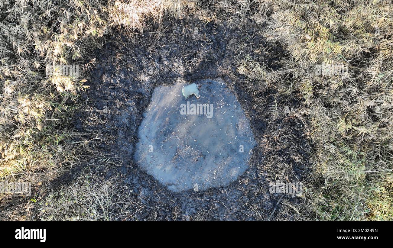 Puddle swamp dig spade worker man drone aerial puddle protection ...