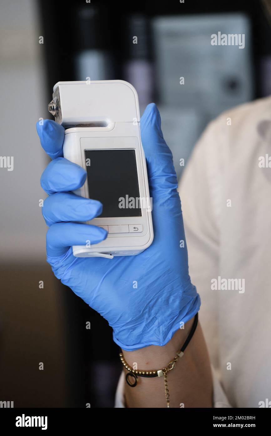 Hands holding special dermatology equipment system, hair loss and ...