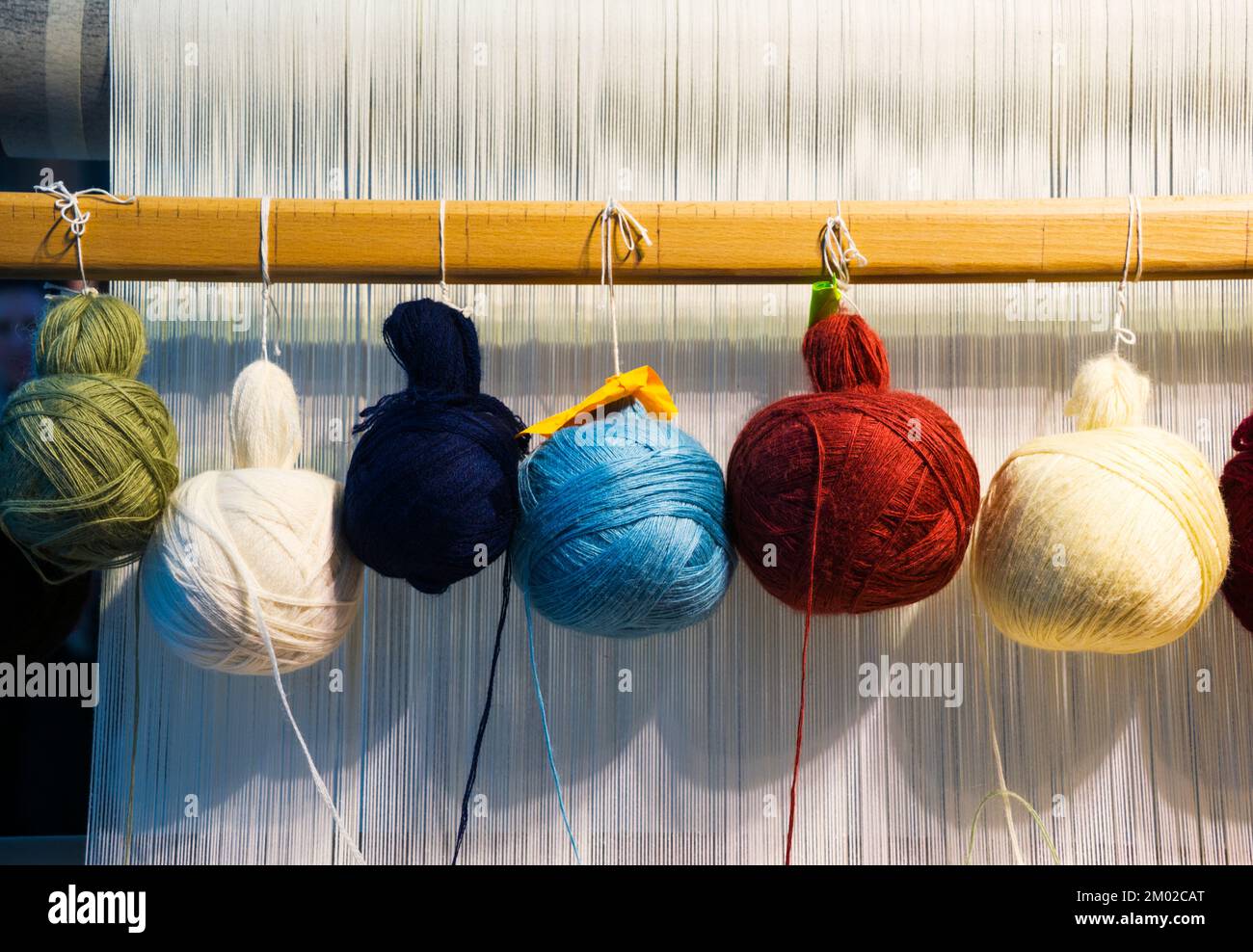 multi-colored wool yarn on a loom for carpets Stock Photo - Alamy
