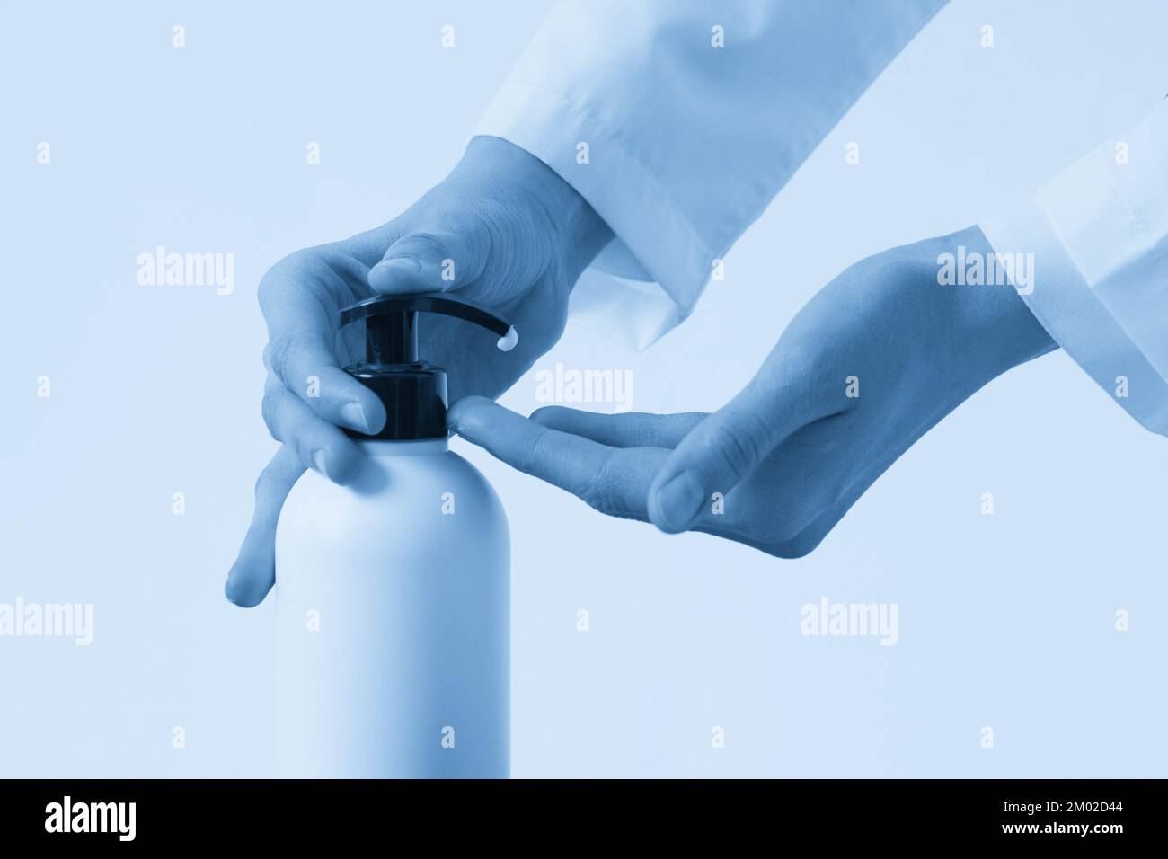 Woman hands pushing pump plastic soap bottle with copy space, using ...