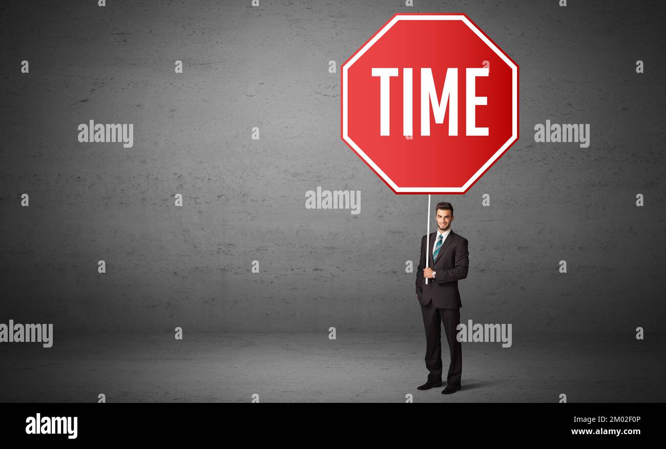 Young business person holding road sign Stock Photo - Alamy