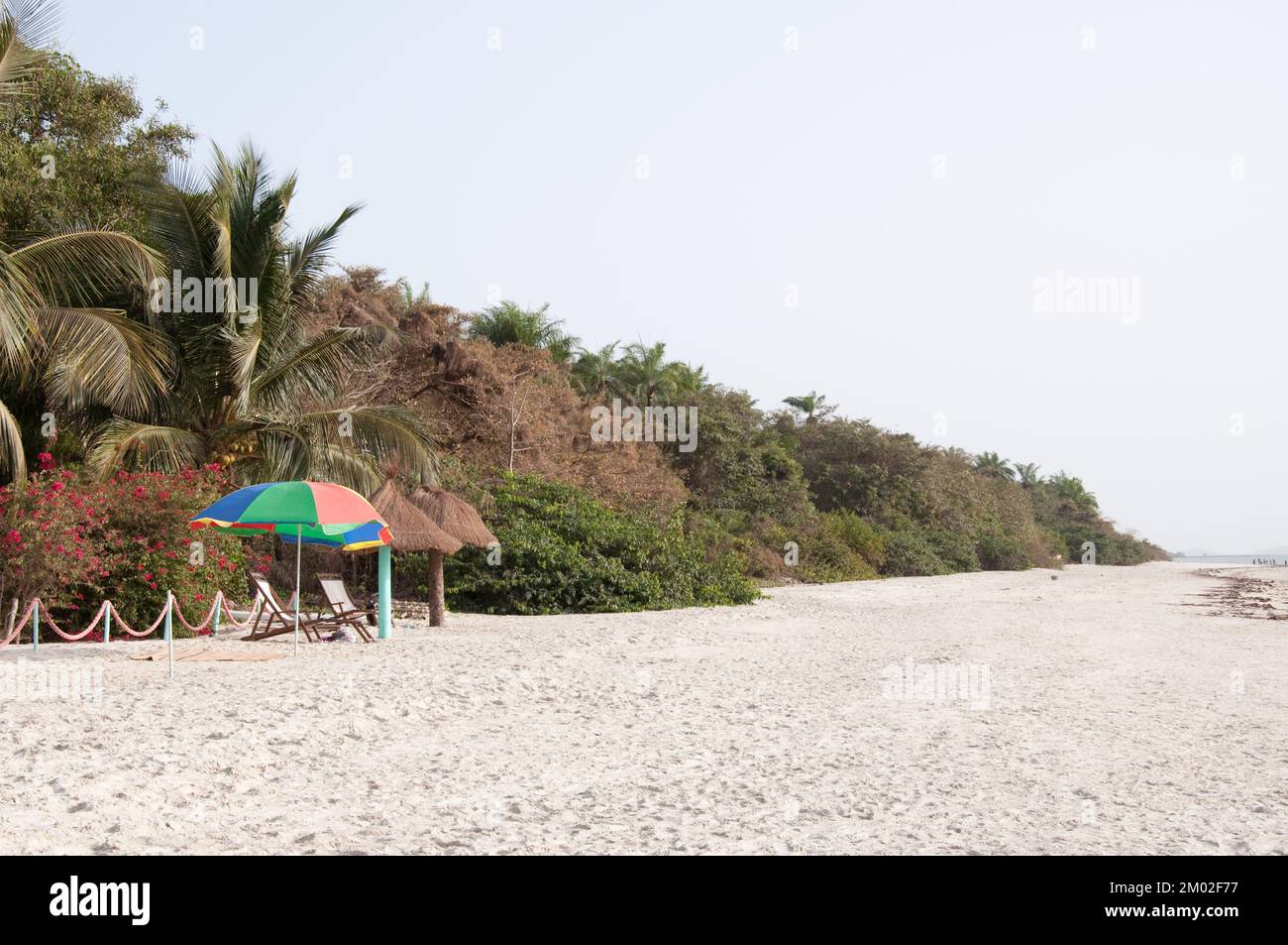 Beach and umbrella, Chez Claude Resort, Island of Joao Viera, Guinea ...