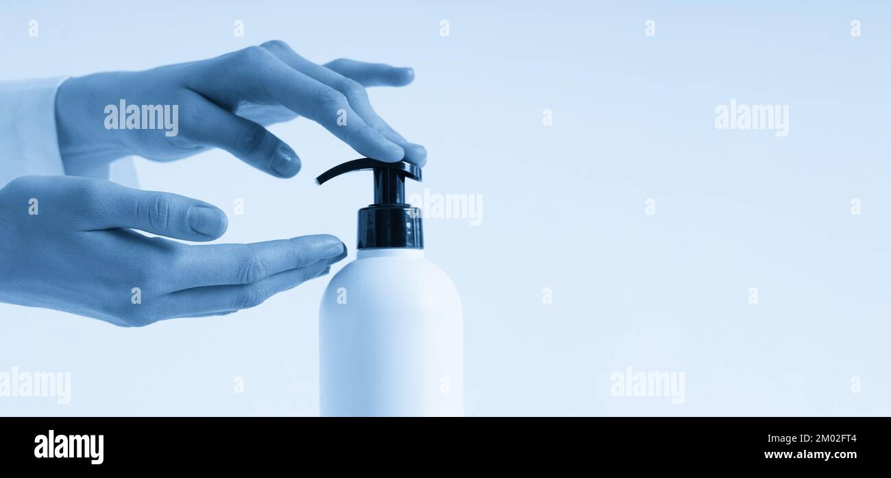 Woman hands pushing pump plastic soap bottle with copy space, using ...